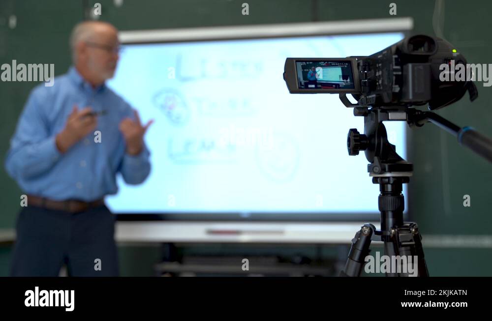 Focus shift from video camera to teacher as very animated male teacher ...