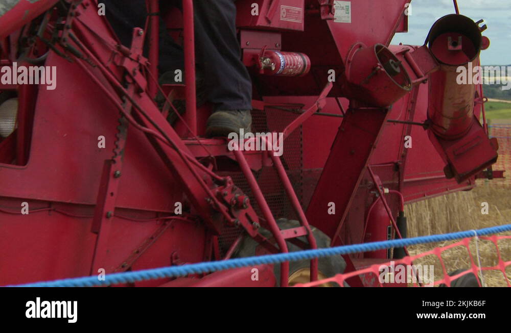 Red vintage antique combine harvester driving diesel engine agriculture ...