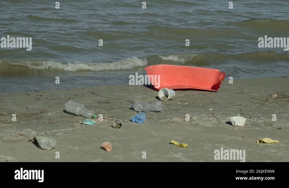 Plastic pollution on the sandy shore. Plastic and other garbage from ...