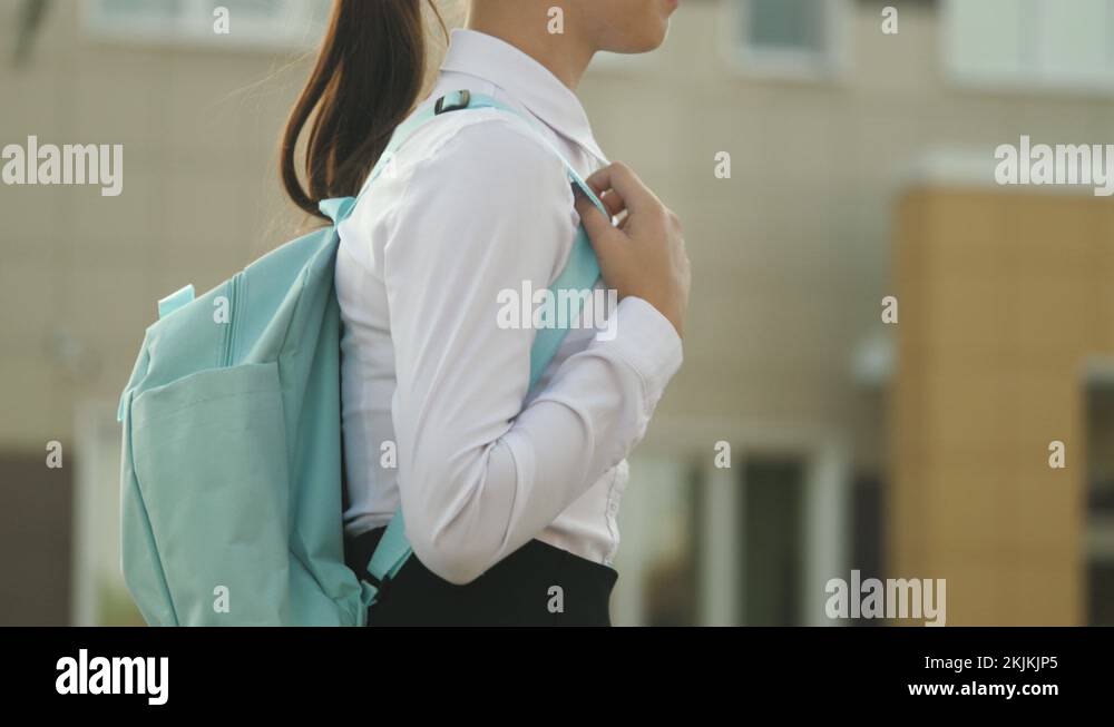 concept of education. a teenage girl hurries to class. a school girl ...