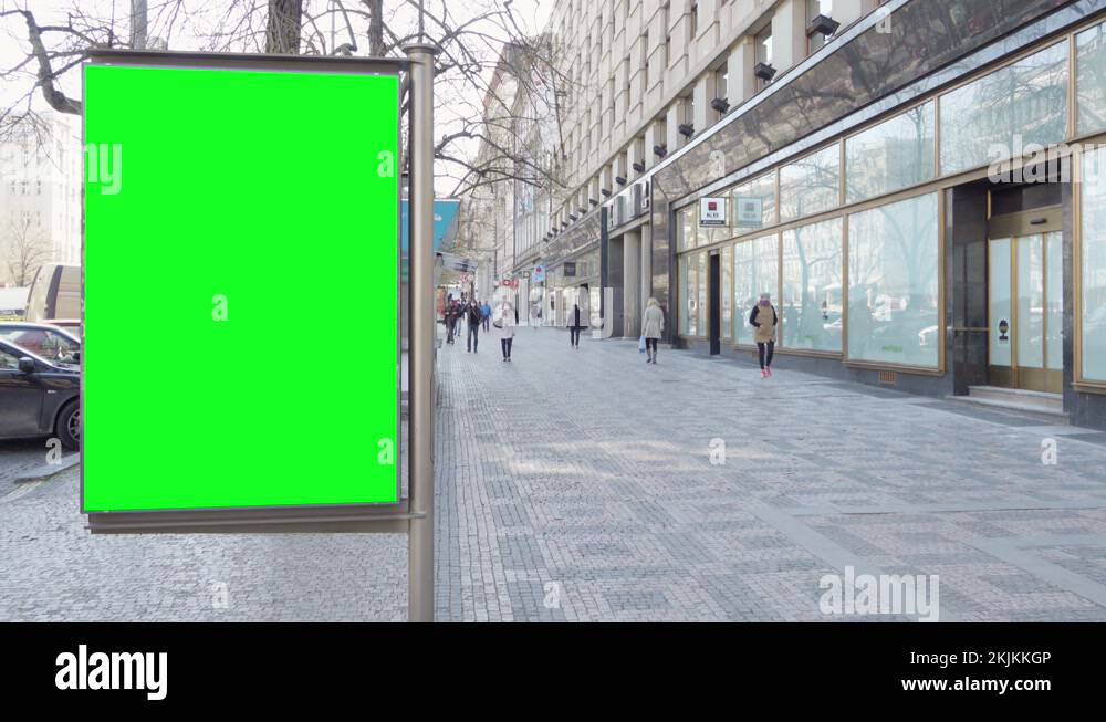 Small billboard sign with green screen in a street in an urban area ...