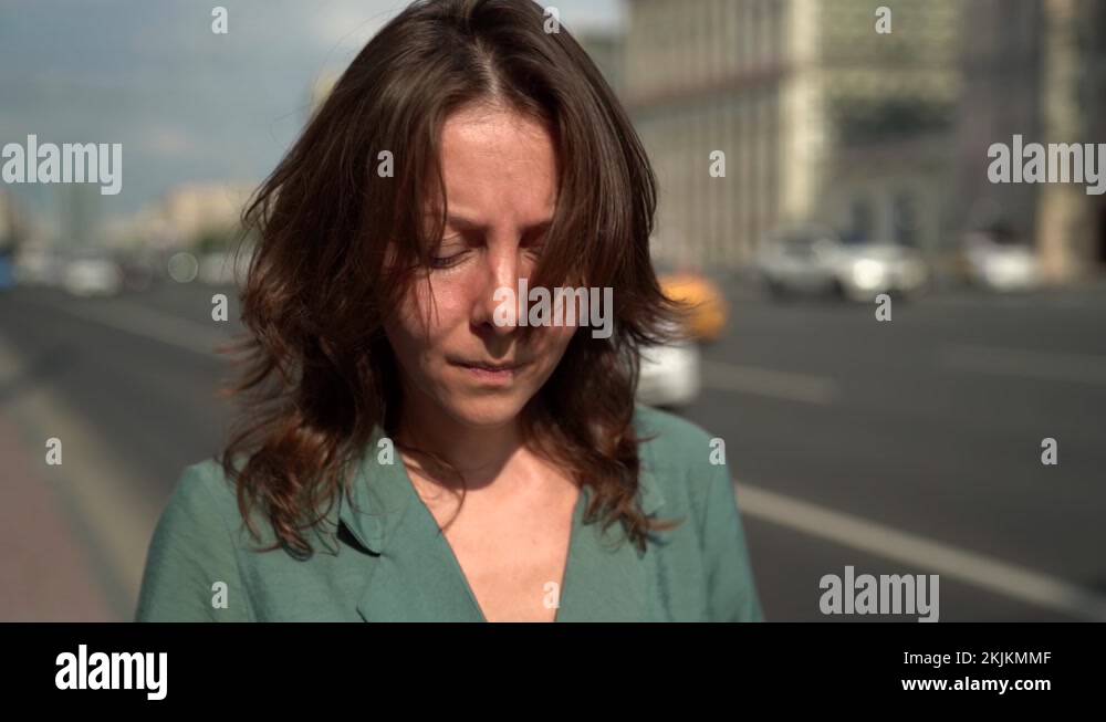 sorrowful woman is crying and going on street, sad face expression ...