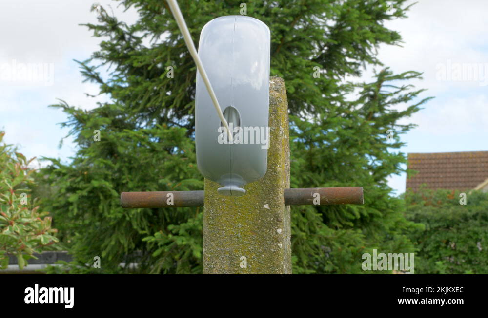 Pulling out a retractable washing line / clothesline on a concrete pole ...