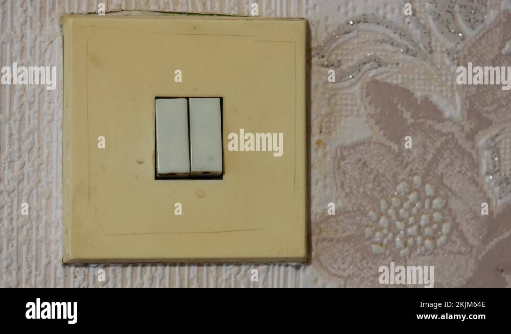Man hand touches the buttons of light switch. Lamp wall switch. Man ...