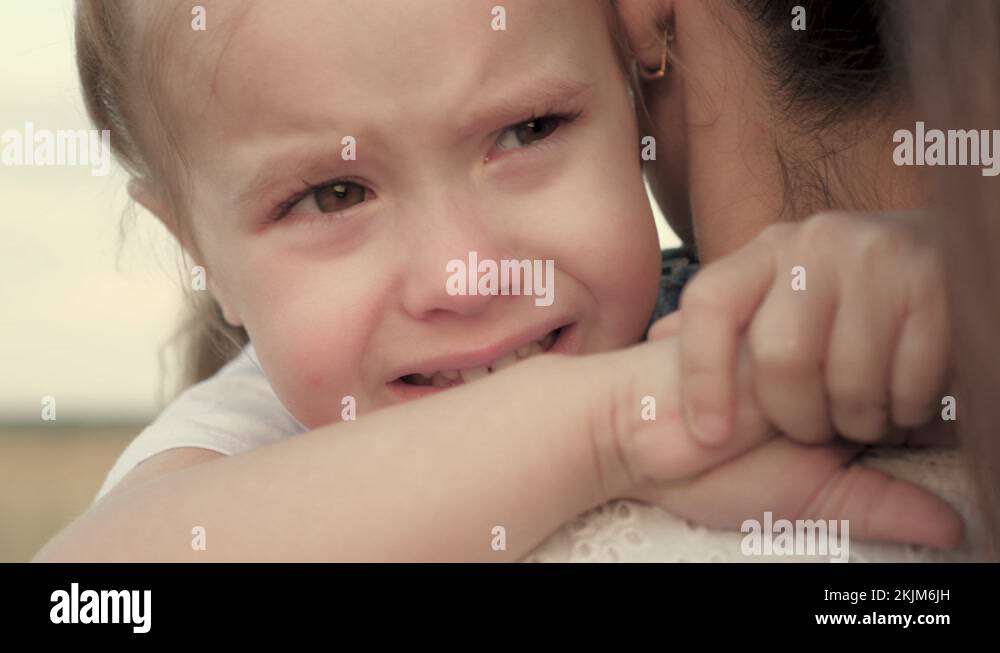 Mommy soothes baby. family mother and child with tears in their eyes ...