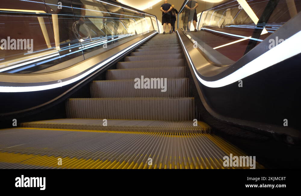 Escalators inside a foyer of a public space in an ultra-modern design ...