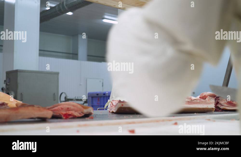 Meat processing plant, butcher cuts pork carcasses, meat production and ...