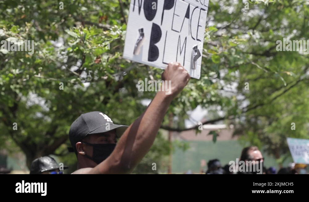Black Lives Matter Protestor at Rally Holding Sign, No Justice No Peace ...