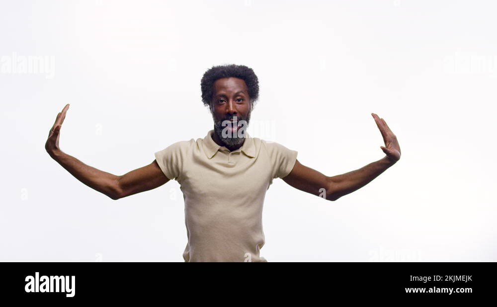 A man dancing pushes his arms out and shakes his head and shoulders ...