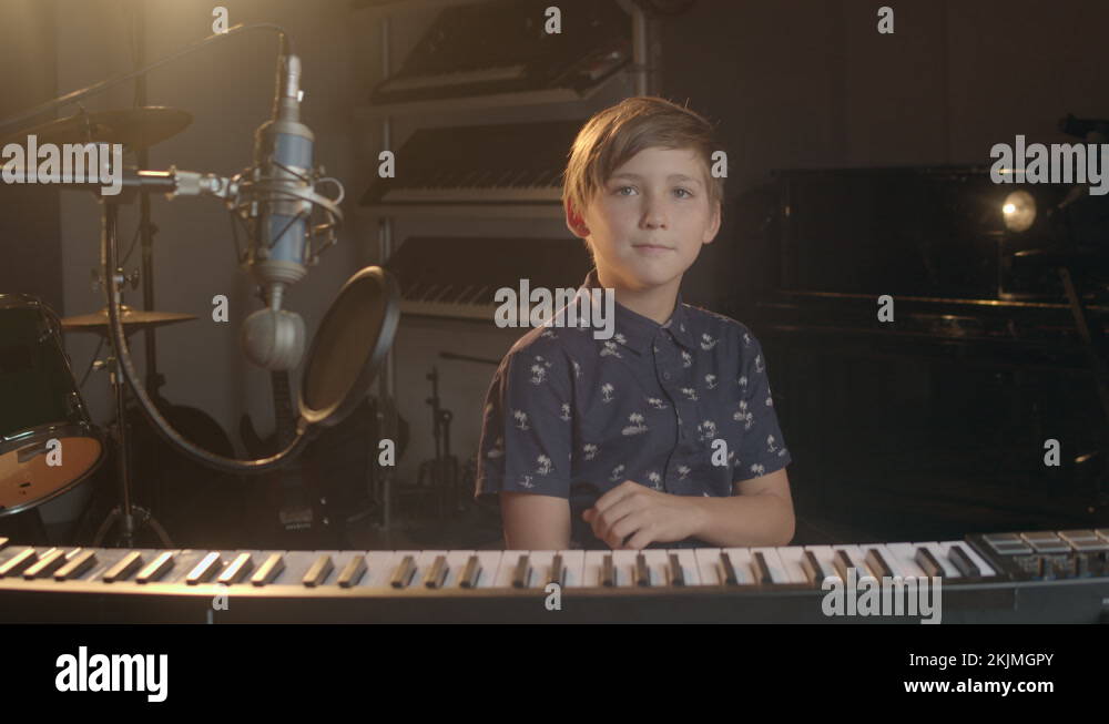 Music and kids. Young musician. Portrait of a kid playing keyboard in ...