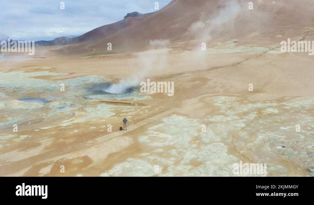 Steaming mud pool with blue orange color in hverir, Iceland, tilt ...