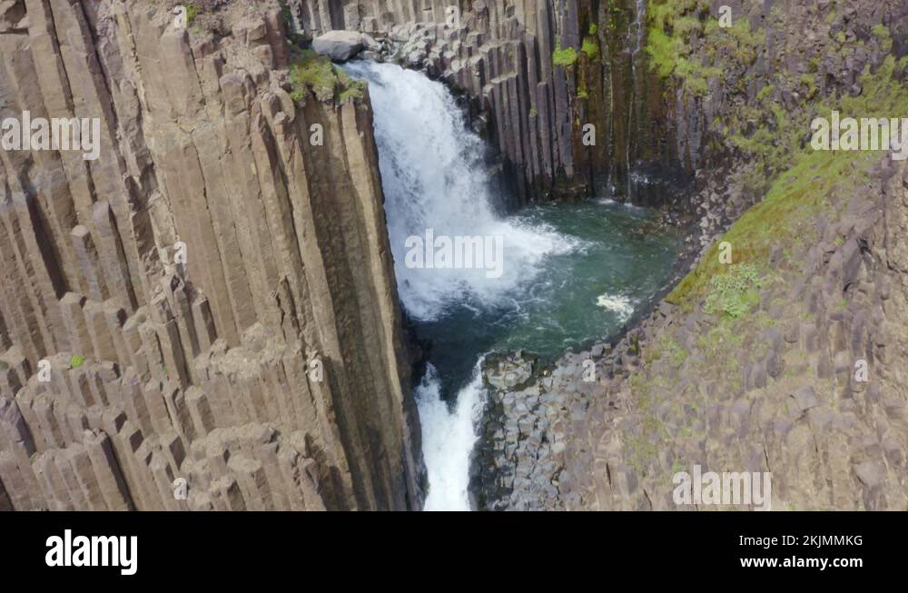Studlabergsfoss waterfall narrow and long cascade around hexagonal ...