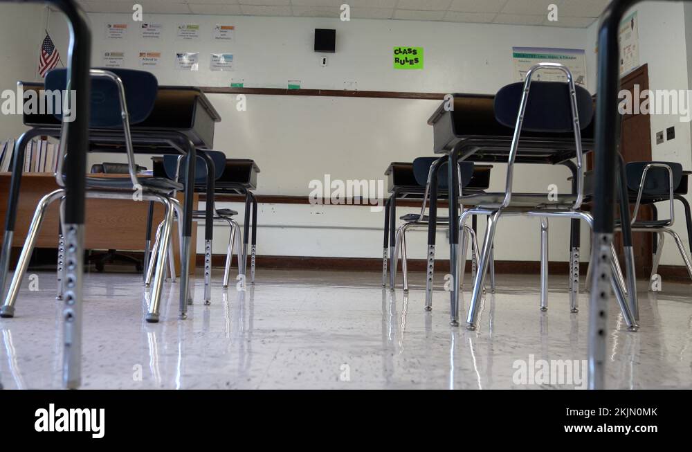 Floor view motion to the left showing empty school classroom with ...