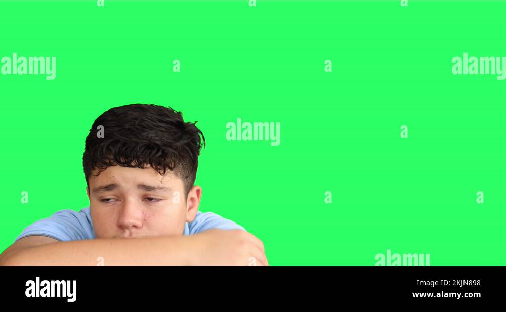 Sad teenager looking at camera at green screen background 1 Stock Video ...