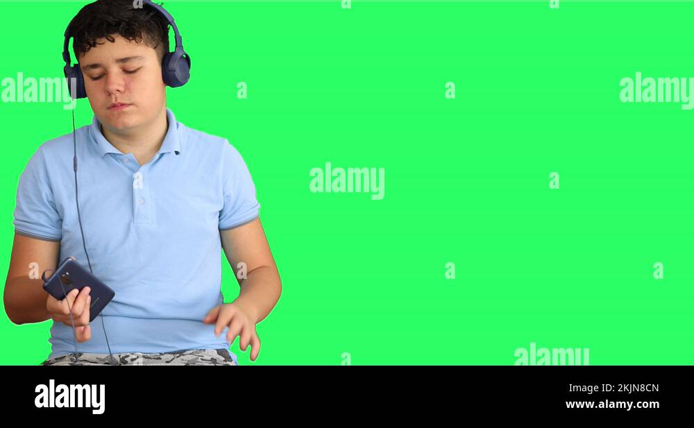 Teenage boy with headphone at green screen background 1 Stock Video ...