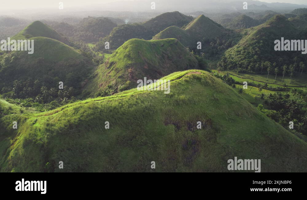 Philippines hilly countryside aerial: misty haze over mountain ranges ...