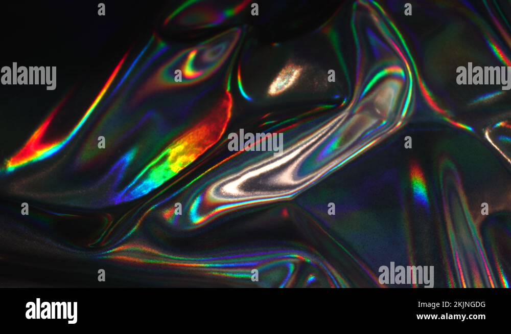 Iridescent rainbow colored holographic shiny fabric. Liquid metallic ...