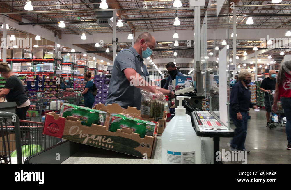 Busy Costco checkout line during Covid 19 pandemic. People wearing ...