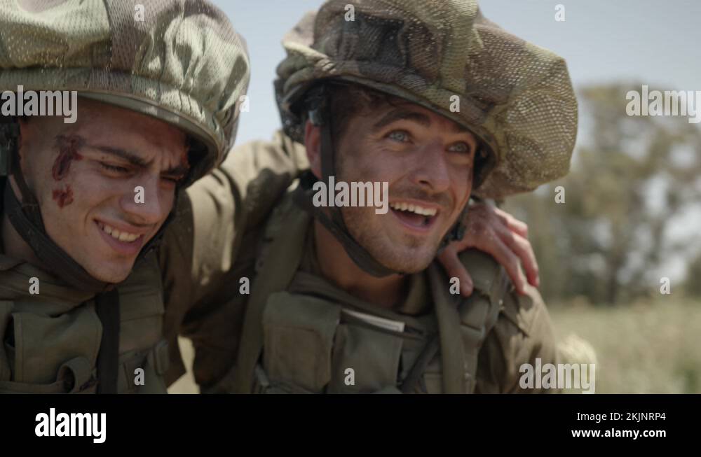 Army infantry soldier carrying his wounded fellow warrior, while ...