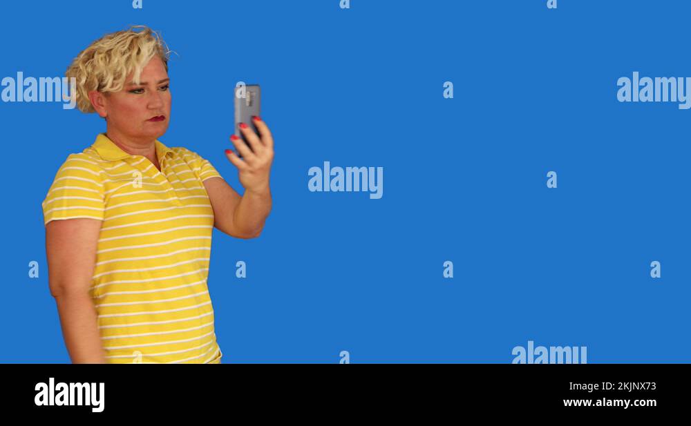 Woman taking selfie at blue screen chroma key background Stock Video ...