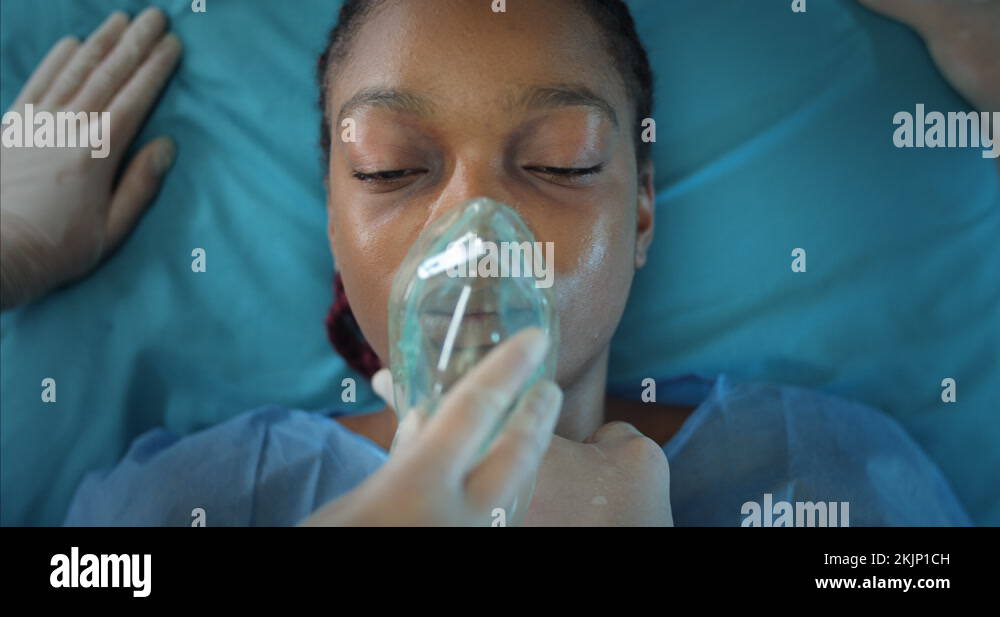 Close Up Of Paramedics Take Off Oxygen Inhalation Mask From Afro