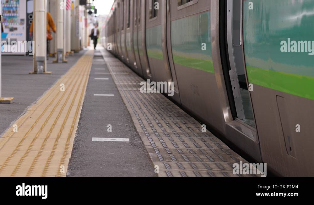 Passenger lady board on rapid transit train, low half shot of legs ...
