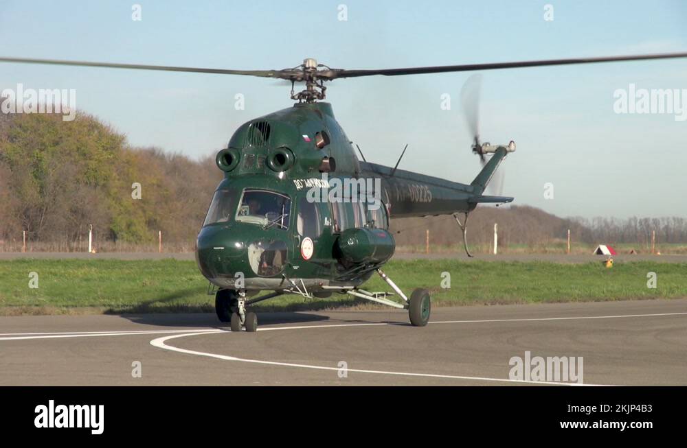 Helicopter Mi-2 (NATO: Hoplite) moves along taxiway towards ground ...