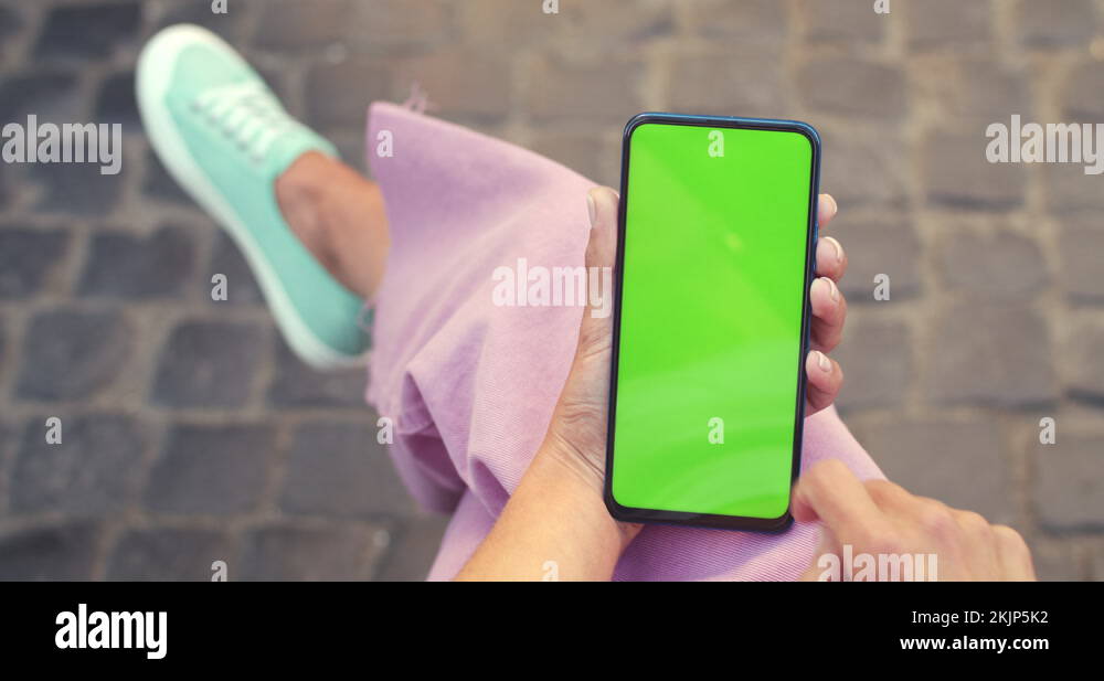 Crop view of female person swiping and pressing on mockup screen while ...