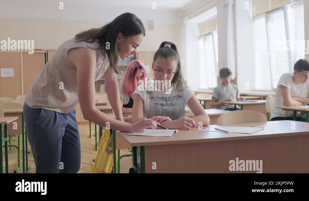 Lesson in class, young female teacher teaches teenage girl, group of ...