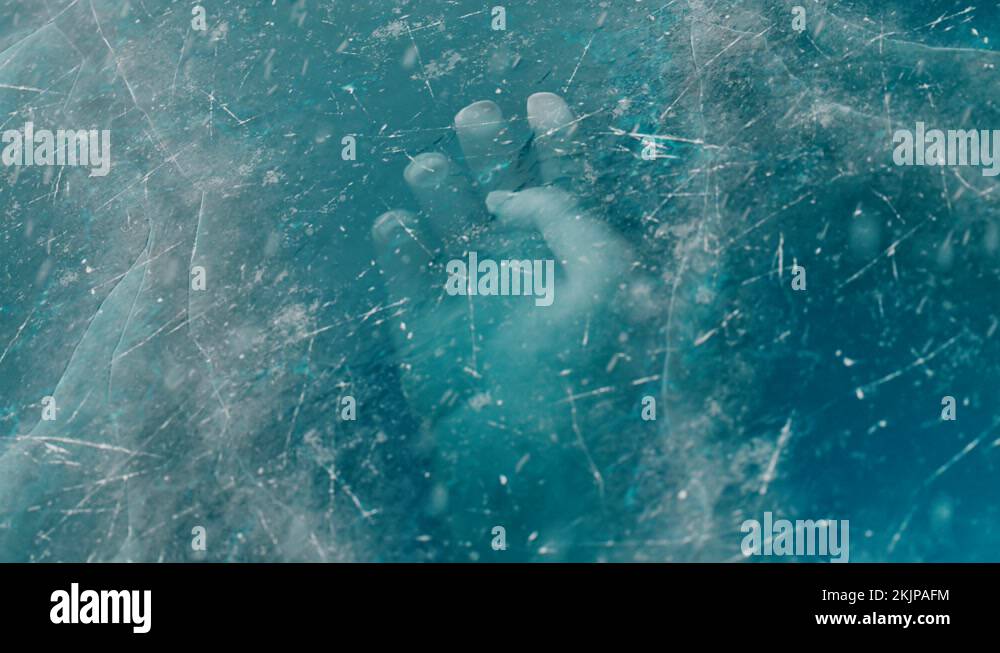 A human hand under the ice. The dead body is trapped underwater below ...