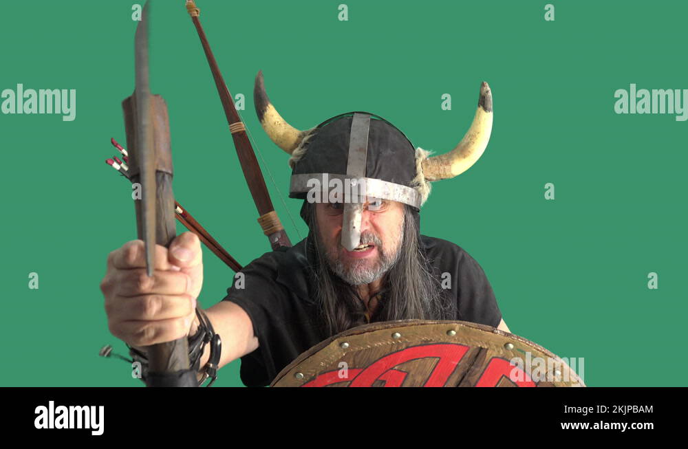 Portrait of an aggressive angry elderly viking wearing a helmet with ...