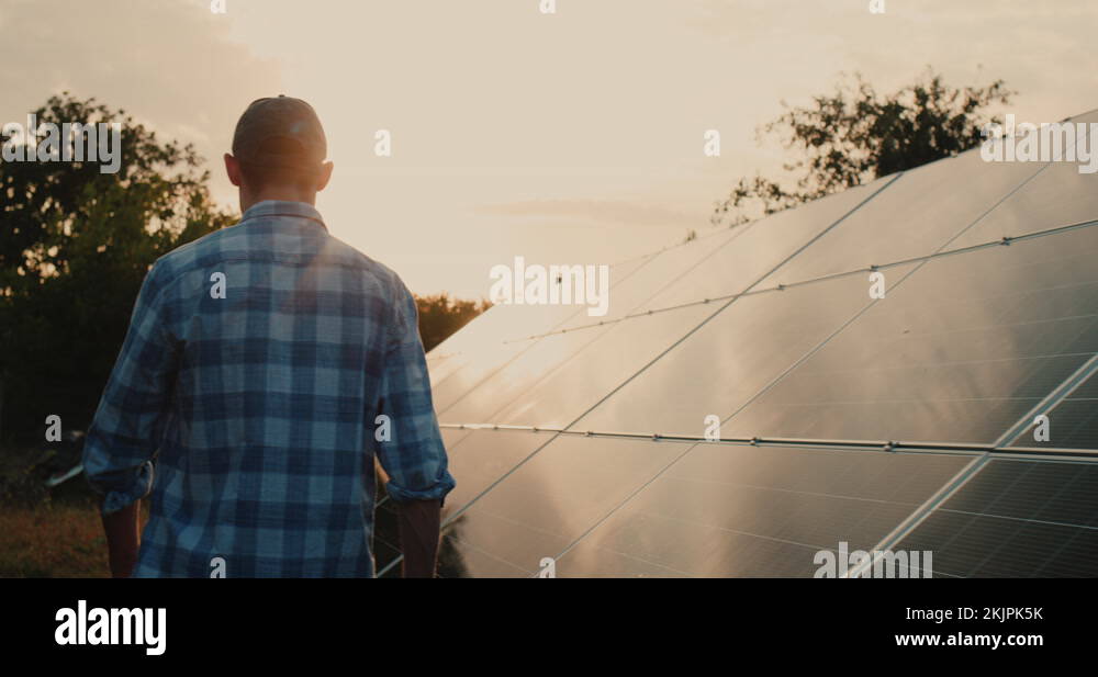 The owner walks along the panels of the terrestrial solar power plant ...