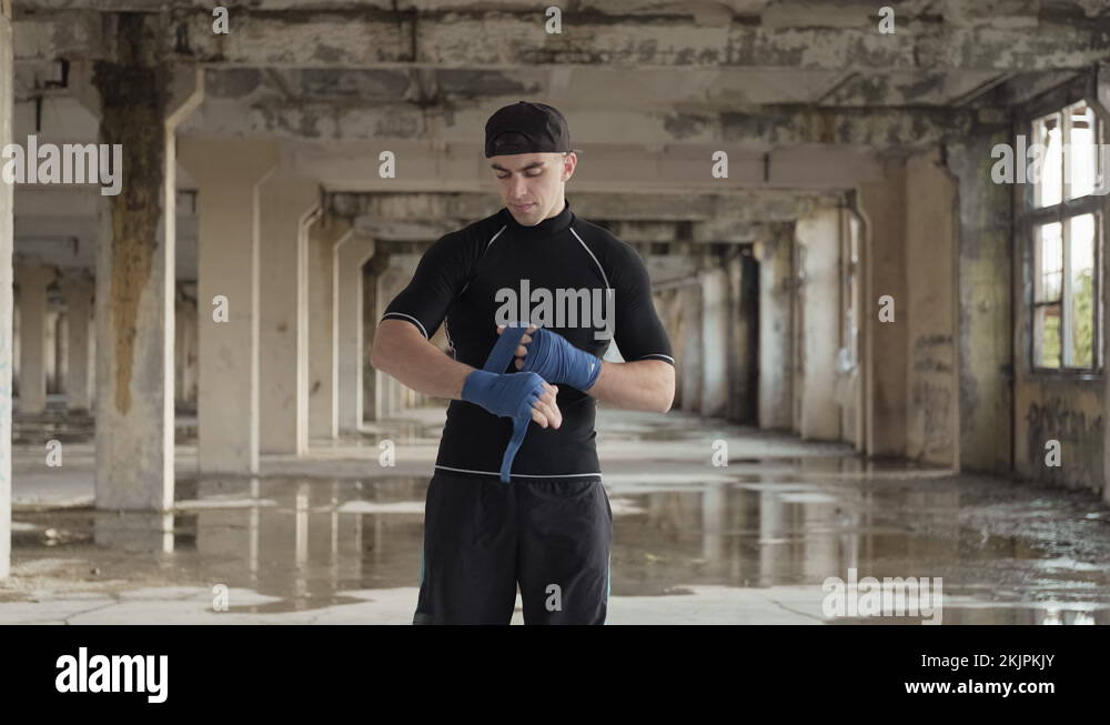 Boxer wrapping hands before fighting. Young athlete getting ready for ...