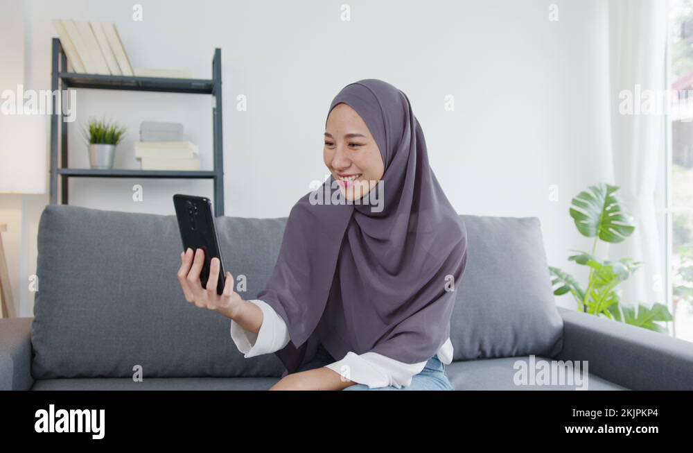 Asia muslim lady wear hijab using phone video call talking with couple ...