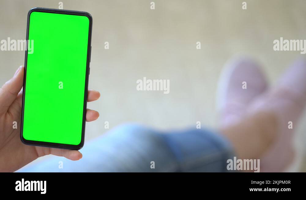 Handheld Camera: Back view of brunette holding chroma key green screen ...