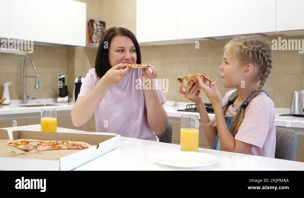 Happy Smiling family of two eagerly eat delicious pizza, little girl ...