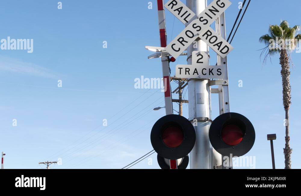 Level crossing warning signal in USA. Crossbuck notice and red traffic ...