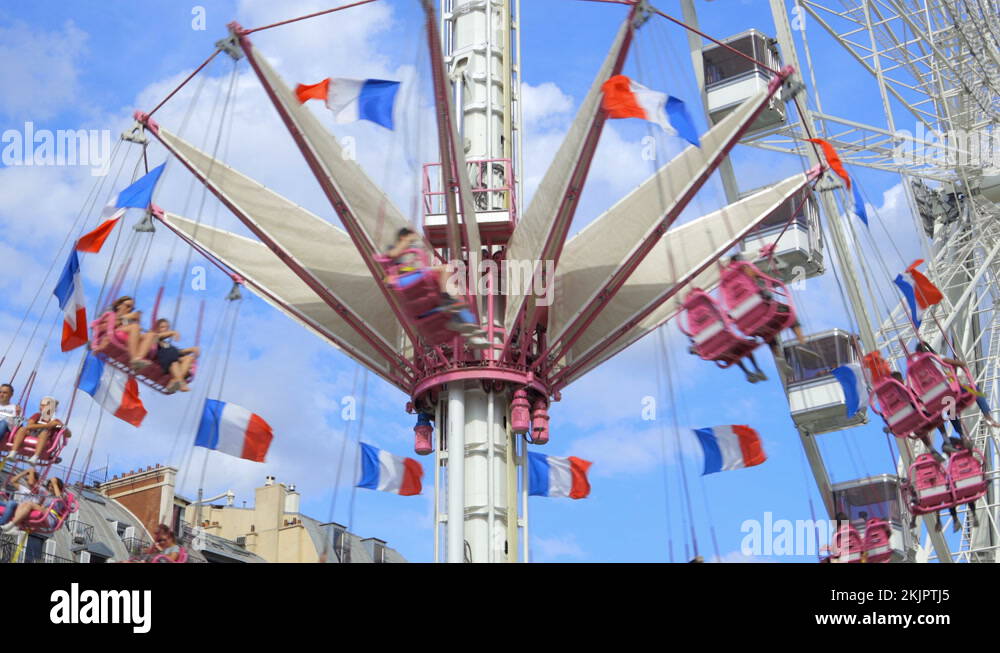 Carousel and Ferris wheel of the Fete des Tuileries in Paris France ...
