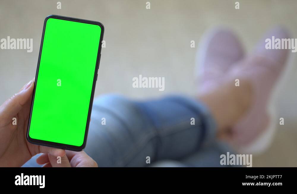 Handheld Camera: Back view of brunette holding chroma key green screen ...