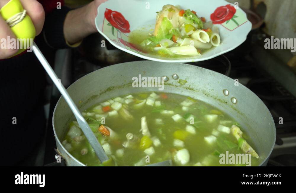 Clouse up cooking and serving homemade minestrone soup, typical ...