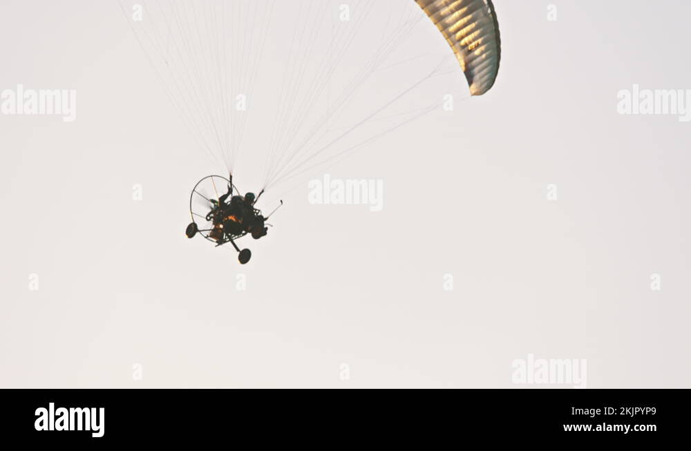 Tandem Paramotor Gliding - two men flying and gliding in the air Stock ...