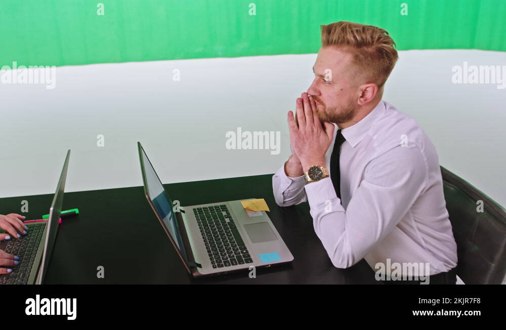 Two men iffy workers while working together at one tablet in a large ...
