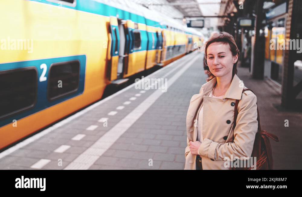 Young Woman Waiting for Train at a Railway Station. SLOW MOTION Stock ...