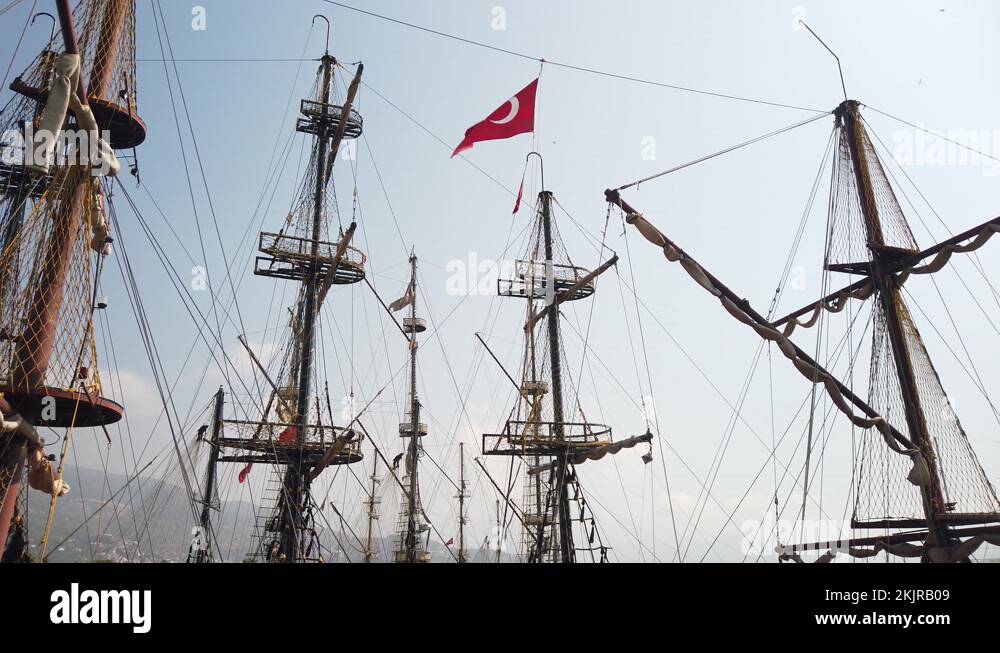 On the deck of a sailing ship, looking up at the main mast and rigging ...