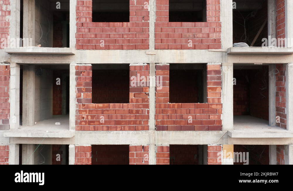 Exterior, non load bearing, red brick walls on a reinforced concrete ...