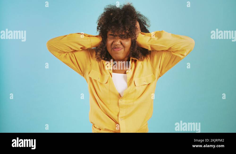 Dark-skinned woman grabbing her head, shaking it like showing no and ...