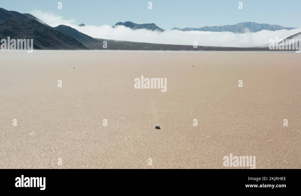 Cinematic 4K aerial of moving stones by smooth cracked surface of ...