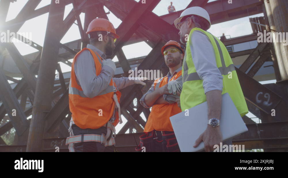 Inspector speaking with builders on construction site Stock Video ...