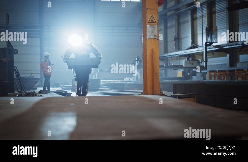 Industrial Factory Worker Wearing Exoskeleton Lifts Heavy Steel ... Industrial Factory Worker Wearing Exoskeleton Lifts Heavy Steel ...