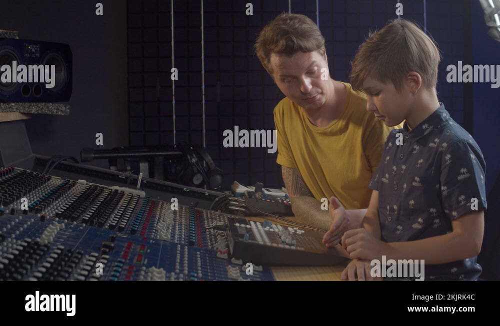 Music production studio. Kid learning about recording methods and the ...